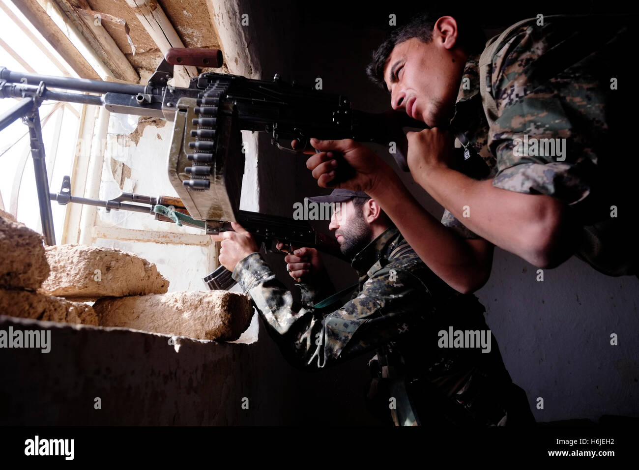Kurdish fighter from the People's Protection Units YPG firing with a 7. ...