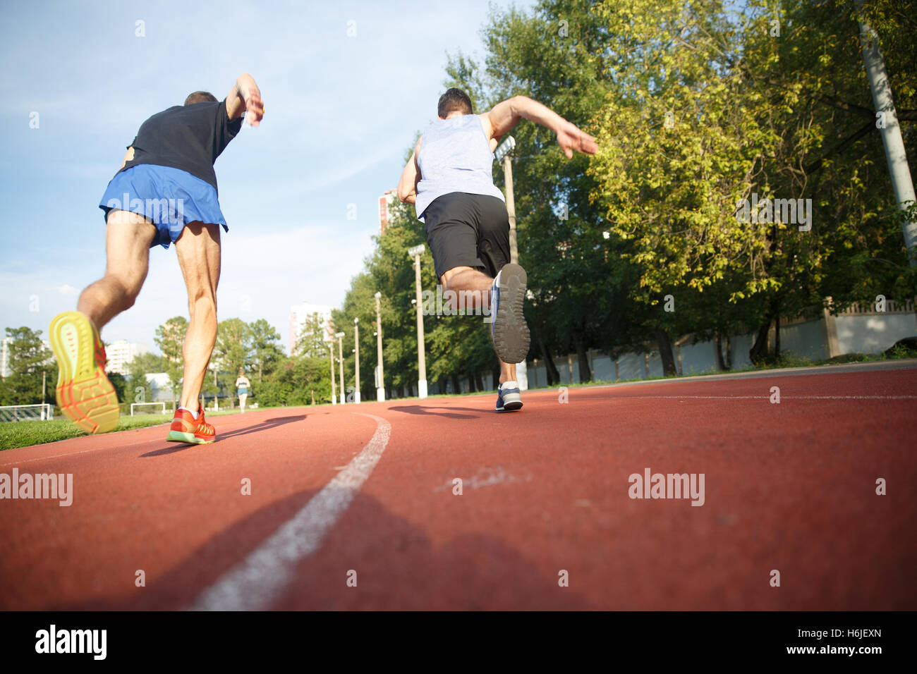 Two male athletes competing on running track Stock Photo - Alamy