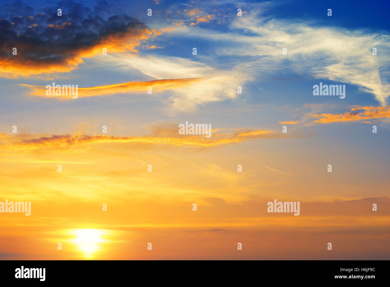 beautiful sunset.the sun rays illuminate the sky above the horizon ...