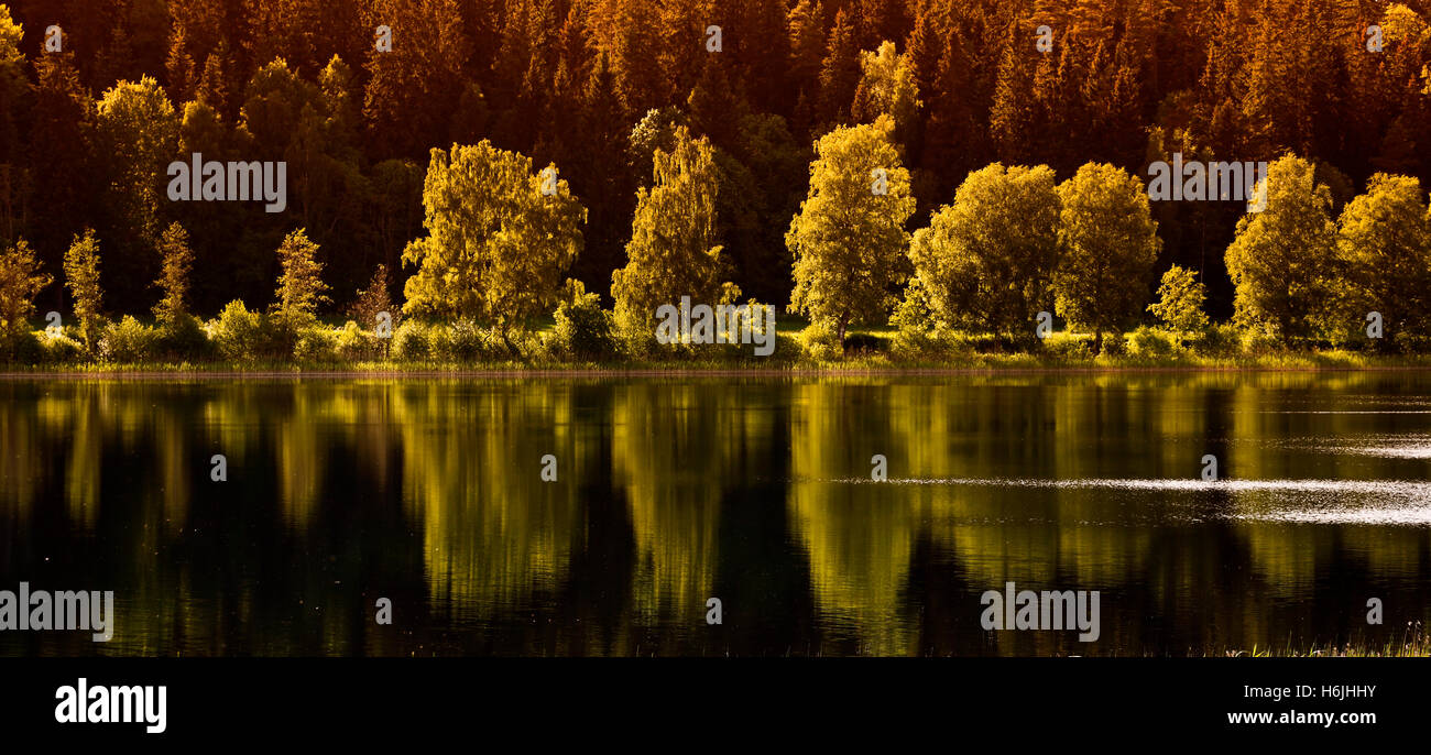 inland lake mirrored in a peaceful landscape Stock Photo - Alamy