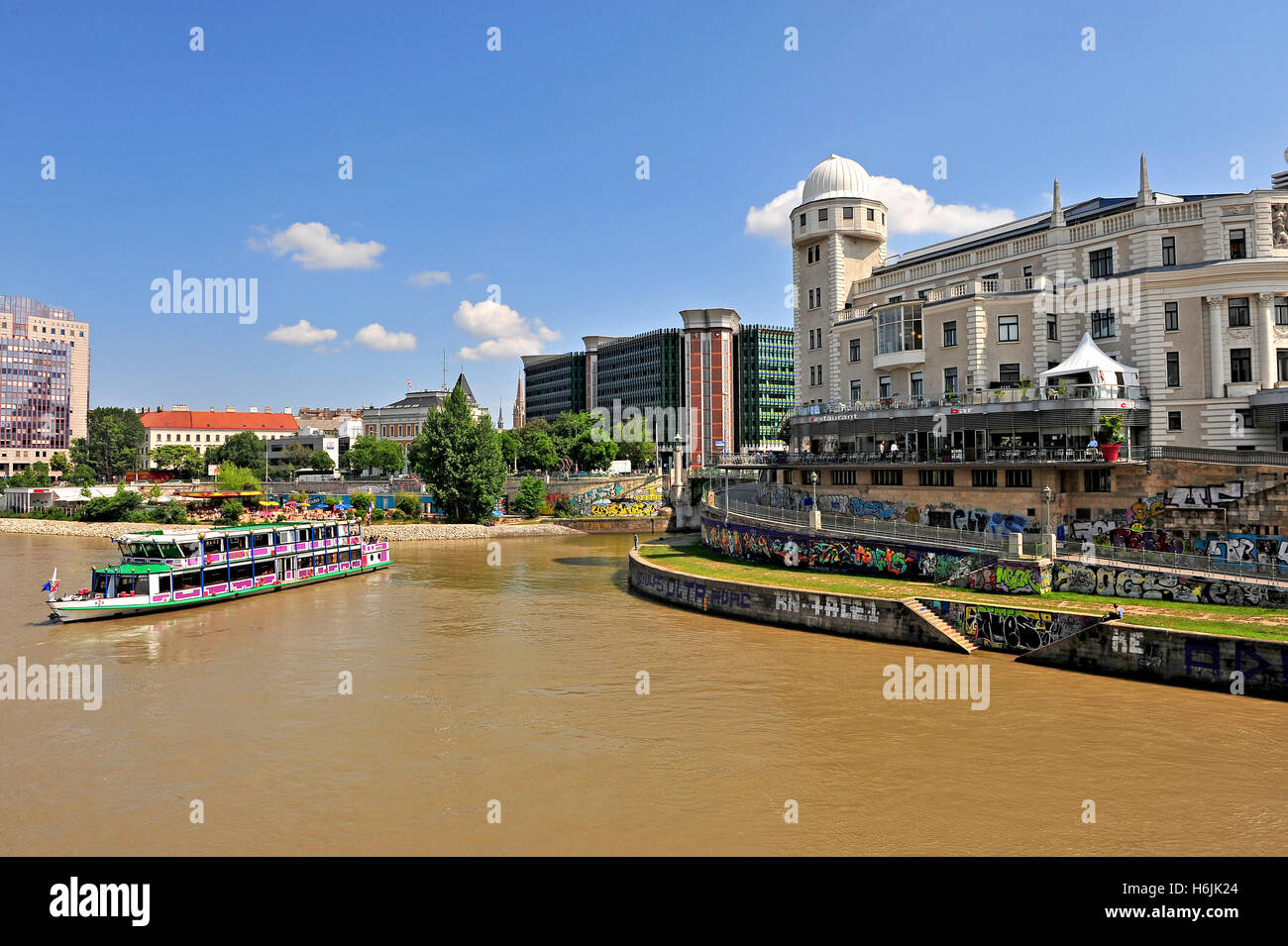 VIENNA, AUSTRIA - JUNE 6: Touristic boat goes by Danube river in Vienna ...