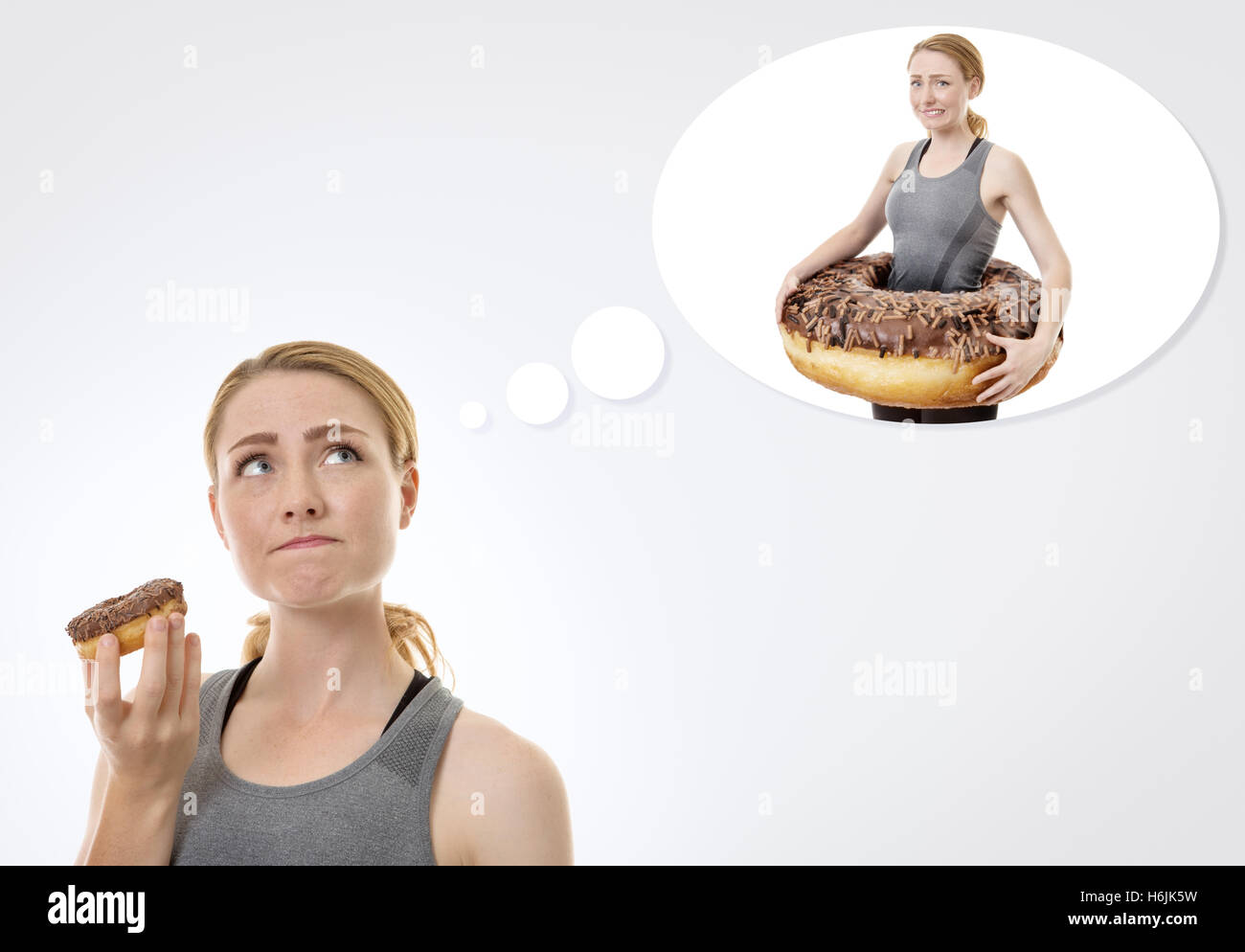 concept idea of a woman about to eat a donut but thinking she shouldn't ...