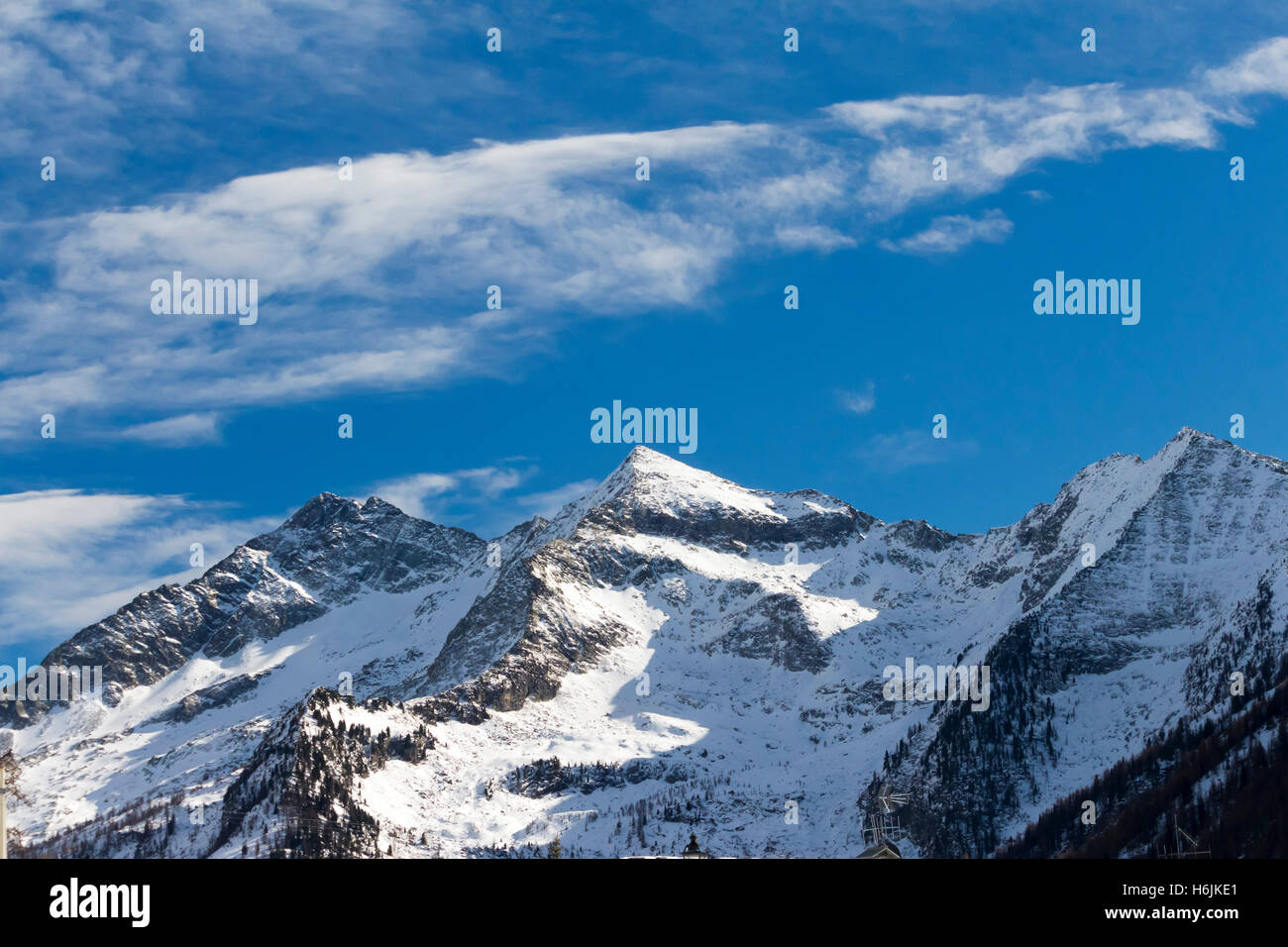 Alpine landscape with mountains, trees and snow Stock Photo - Alamy