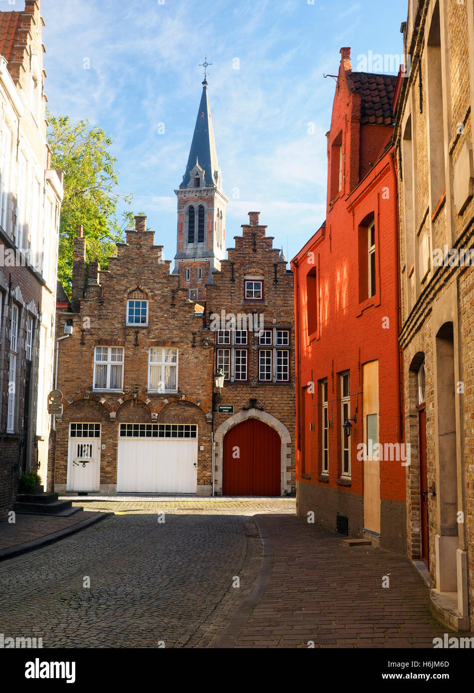 medieval buildings on cobblestone street with garage and cathedral in ...