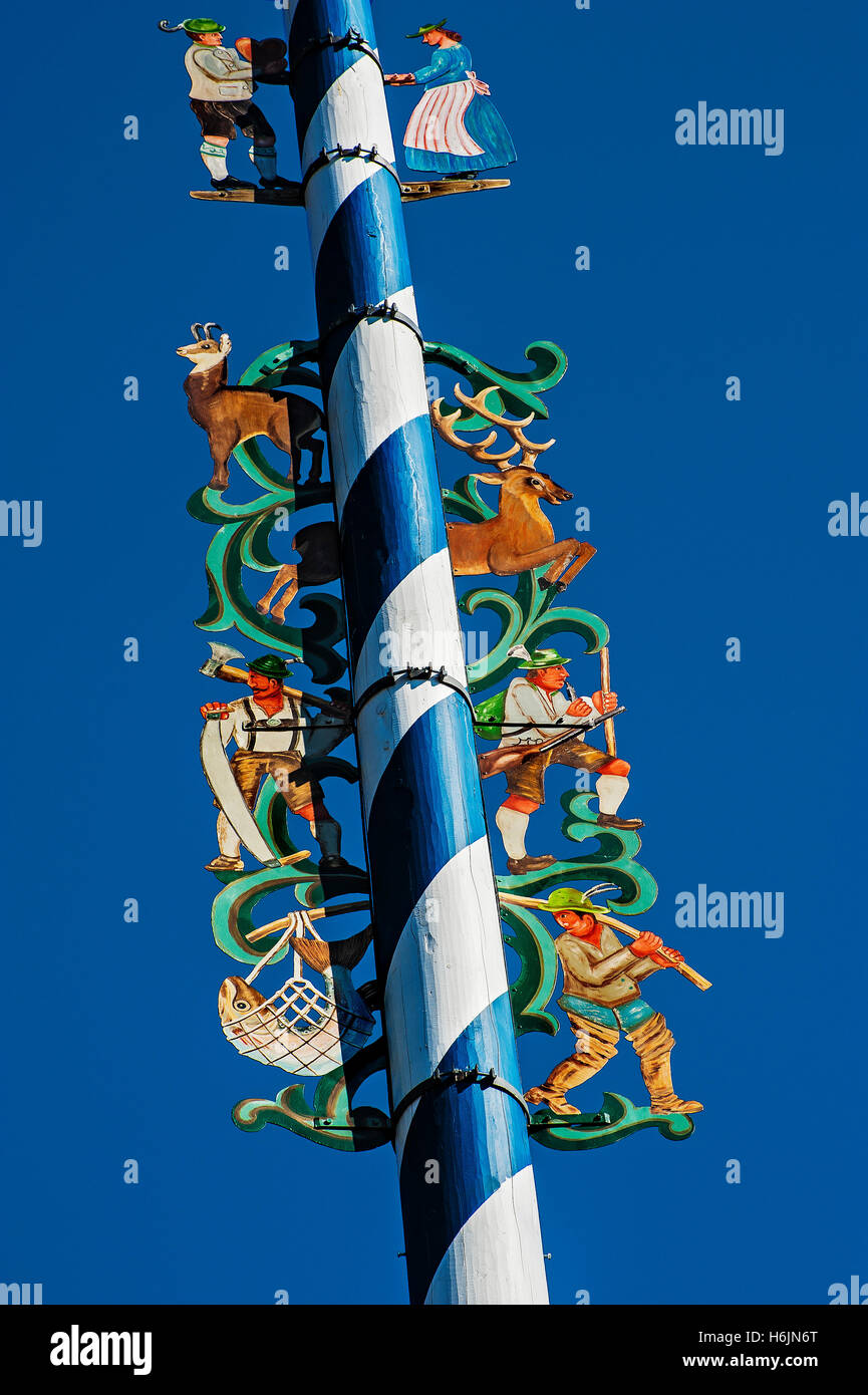 May pole with traditional Bavarian figures in Schliersee, Bavaria ...