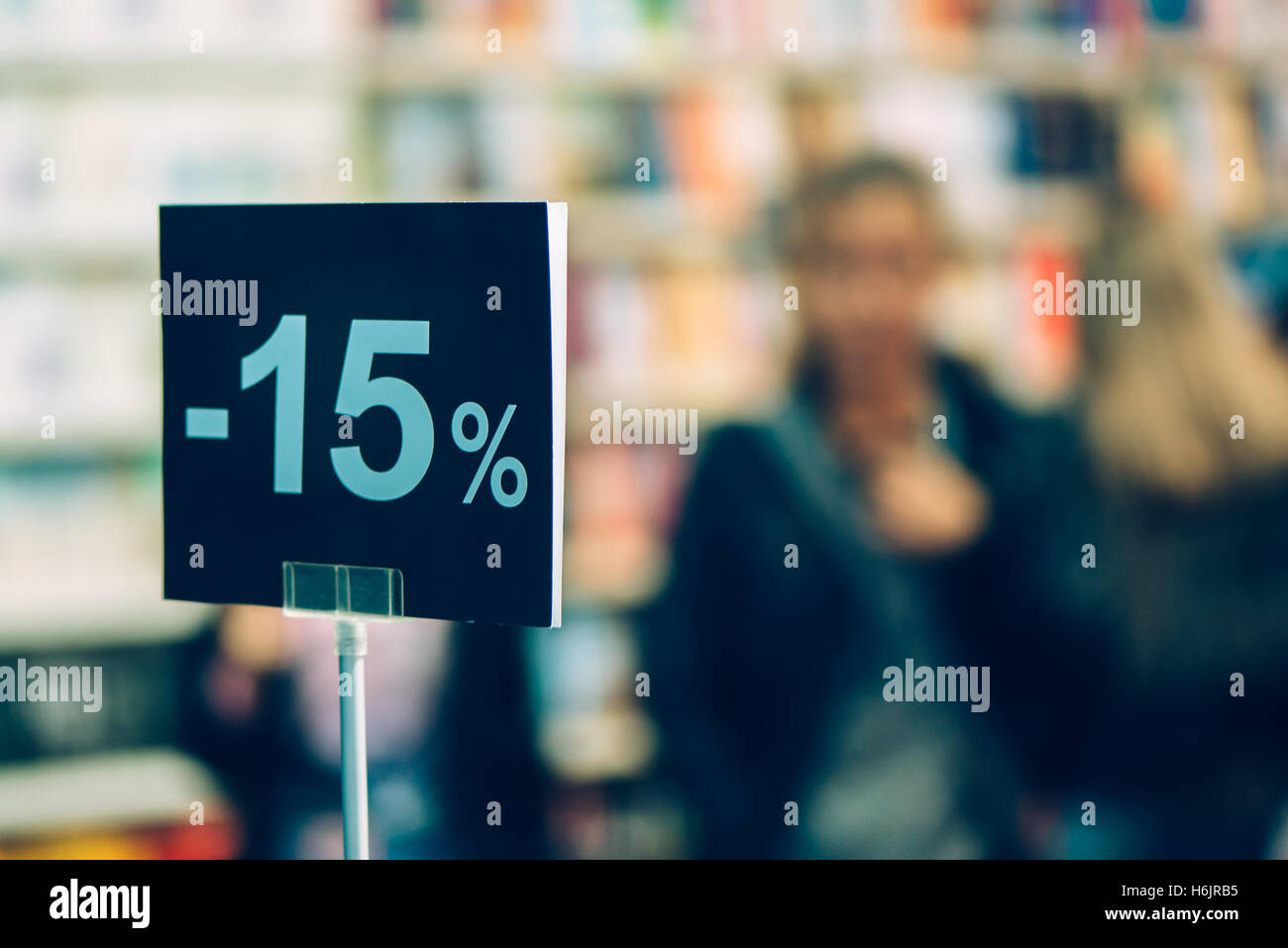 Fifteen percent discount in bookstore, blur customers in background ...
