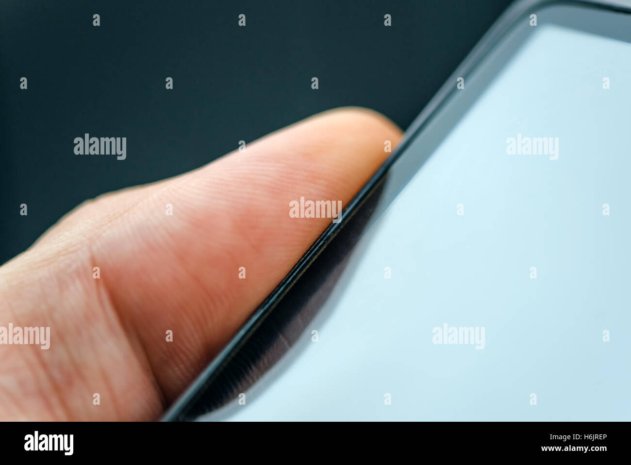 Unlocking smart phone with fingerprint sensor scan, close up with ...
