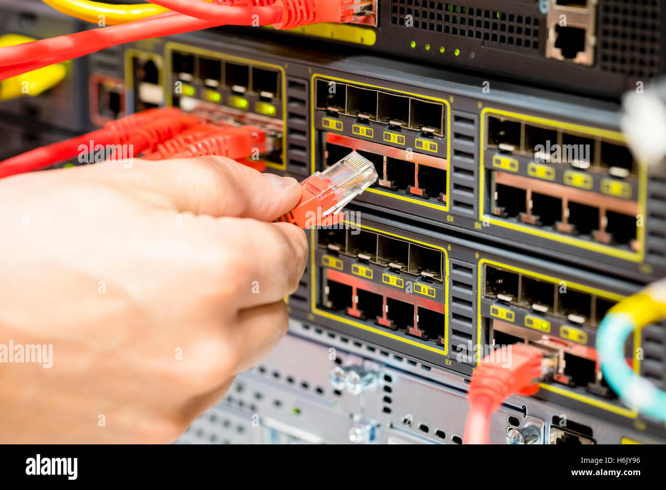 Hand Plugging Fiber Cable Into Switch In Datacenter Stock Photo - Alamy