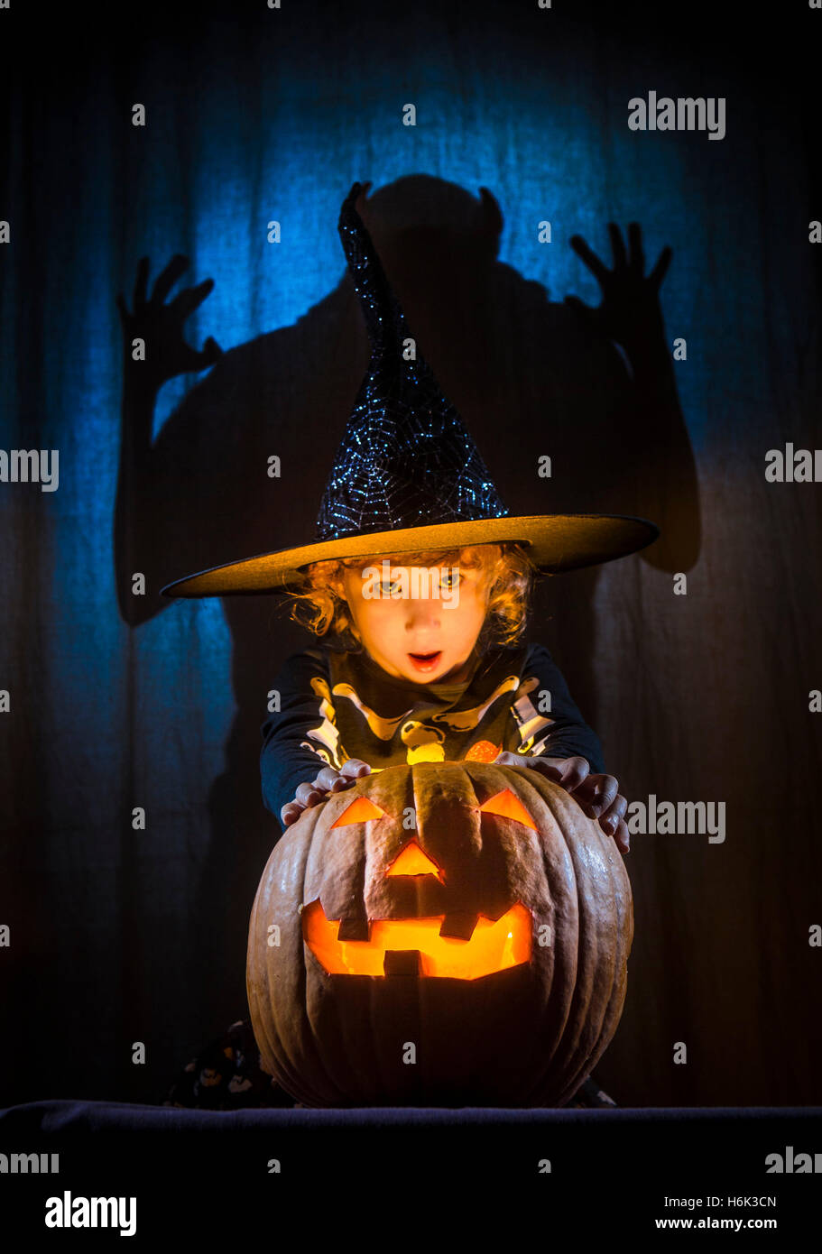 Picture posed by model A young girl in a Halloween costume with a ...