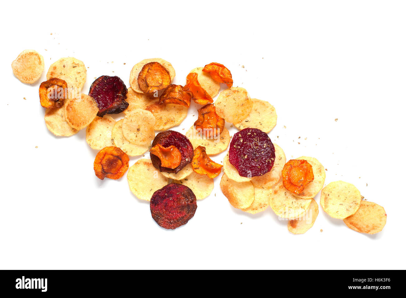 Homemade vegetable chips scattered on white Stock Photo - Alamy