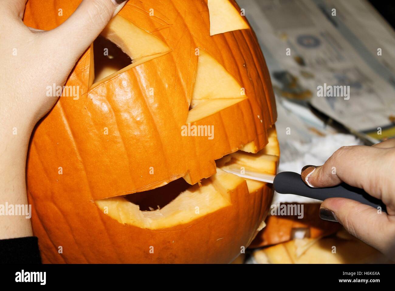 preparation of halloween pumpkin at home with knife Stock Photo - Alamy
