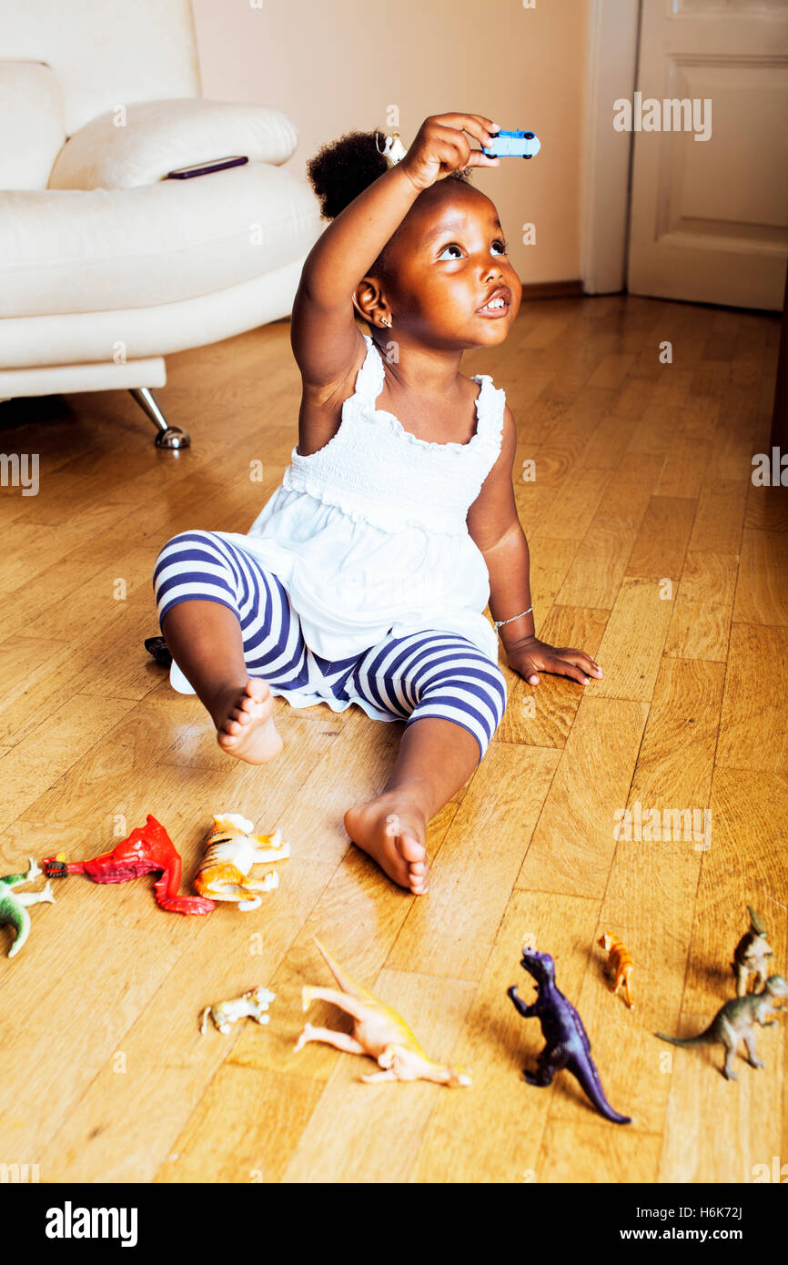 little cute african american girl playing with animal toys at ho Stock ... little cute african american girl playing with animal toys at ho Stock ...