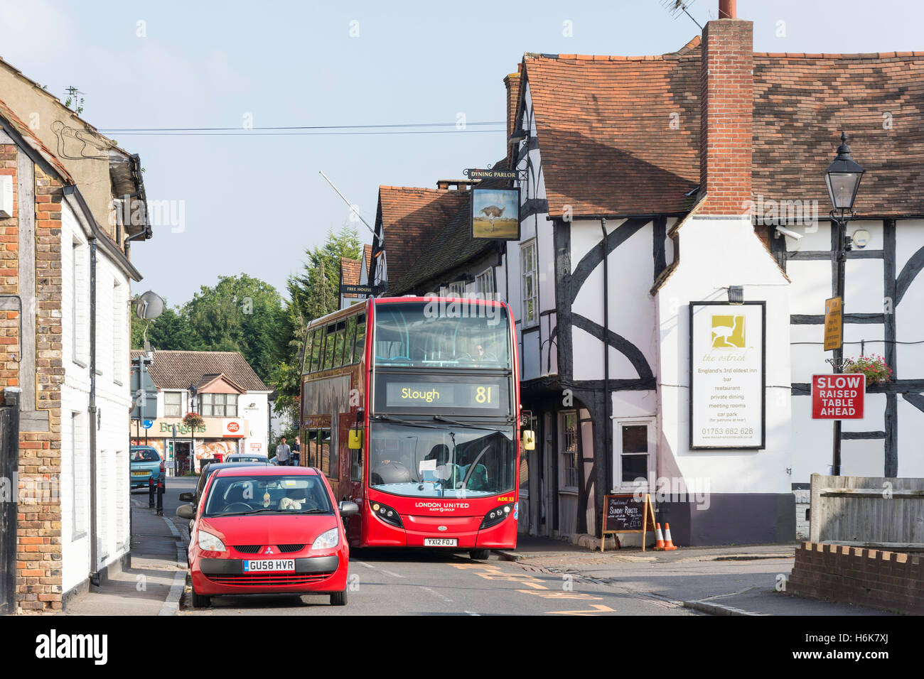 Double-decker bus travelling through High Street, Colnbrook, Berkshire ...