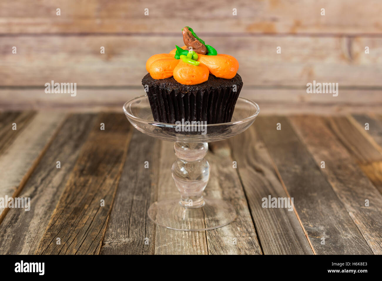 Fall cupcake on a glass stand Stock Photo - Alamy