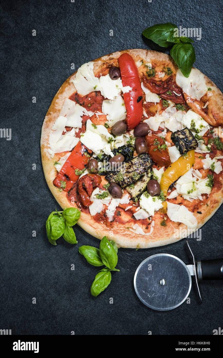 wood-fired traditional Italian pizza, overhead view on dark slate Stock ...