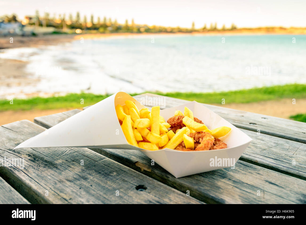Traditional australian calamari rings with chips take away on the table ...