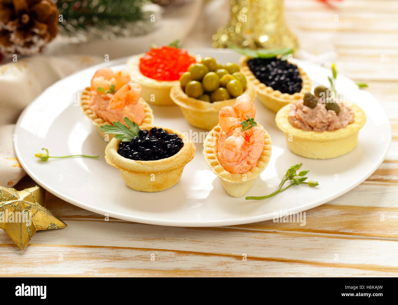 Christmas appetizers. Small tartlets with caviar and pate. Buffet and ...