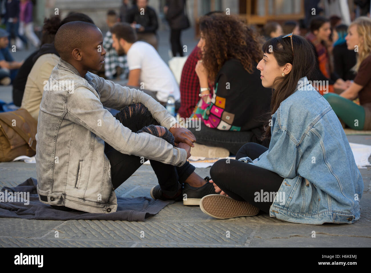 A public event in Perugia, Umbria, Italy – people sit in a city square ...