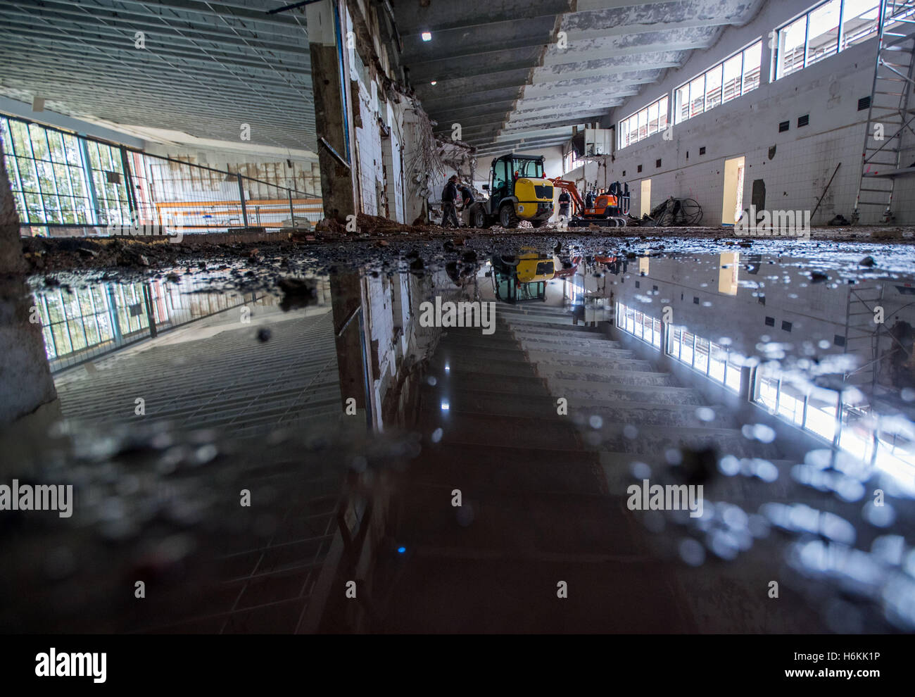 Men work in the former 'people's swimming pool' in the district of ...