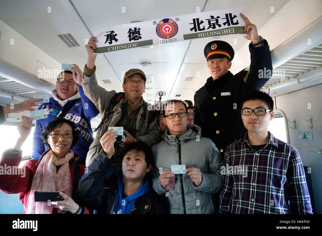 Beijing, China. 31st Oct, 2016. Passengers and train crew take group ...