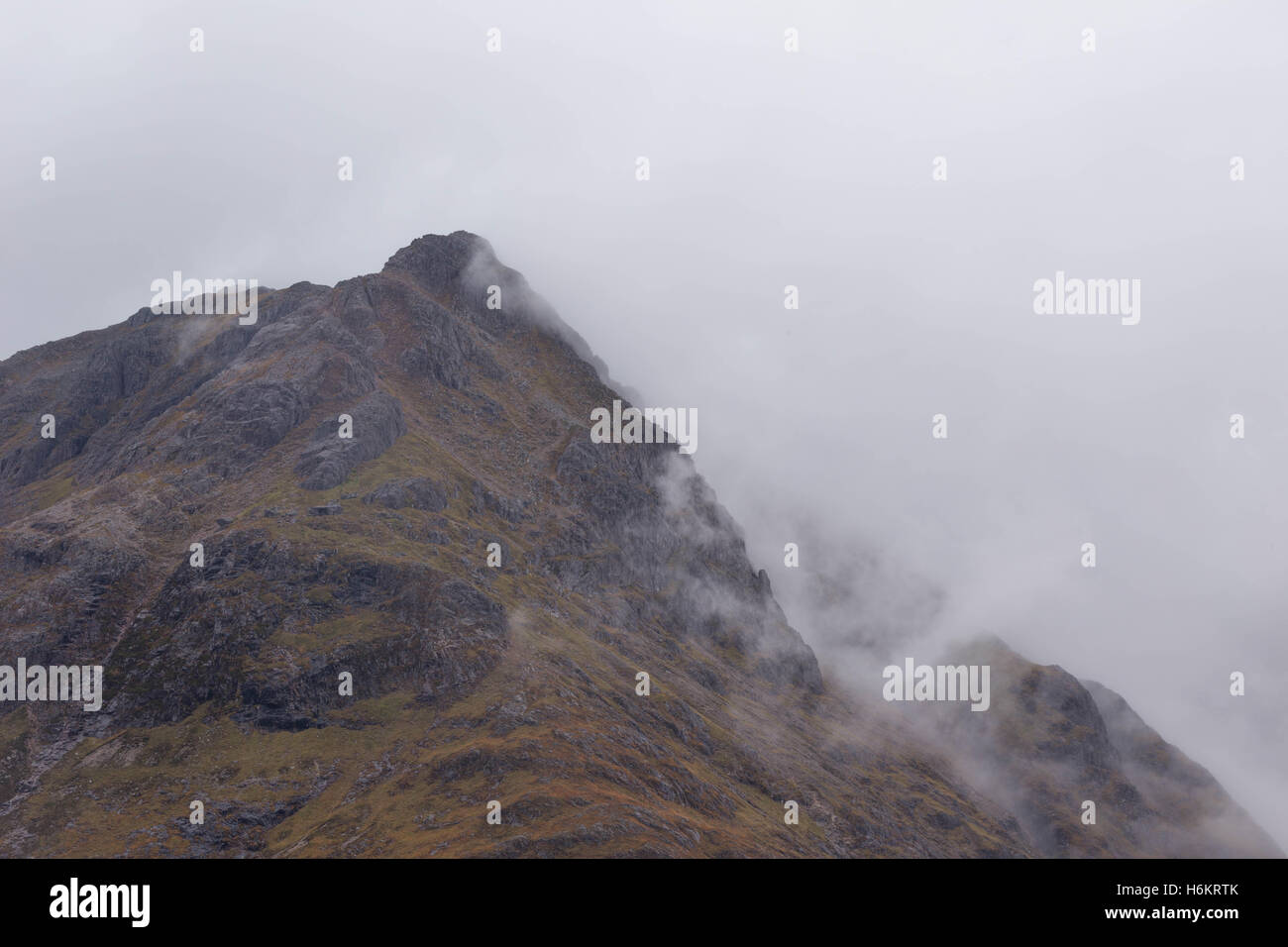 A rocky mountainside in mist Stock Photo - Alamy