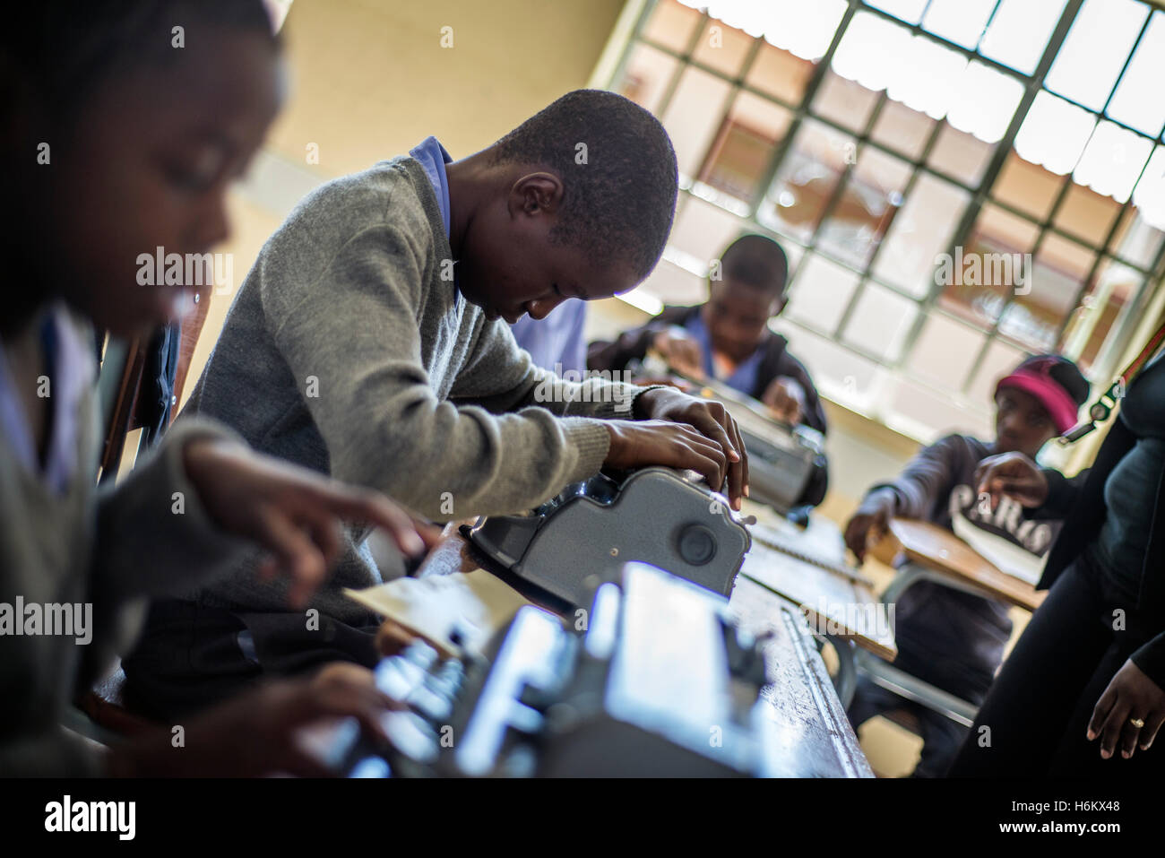 Learners of the Eluwa Special School types on a typewriter during ...