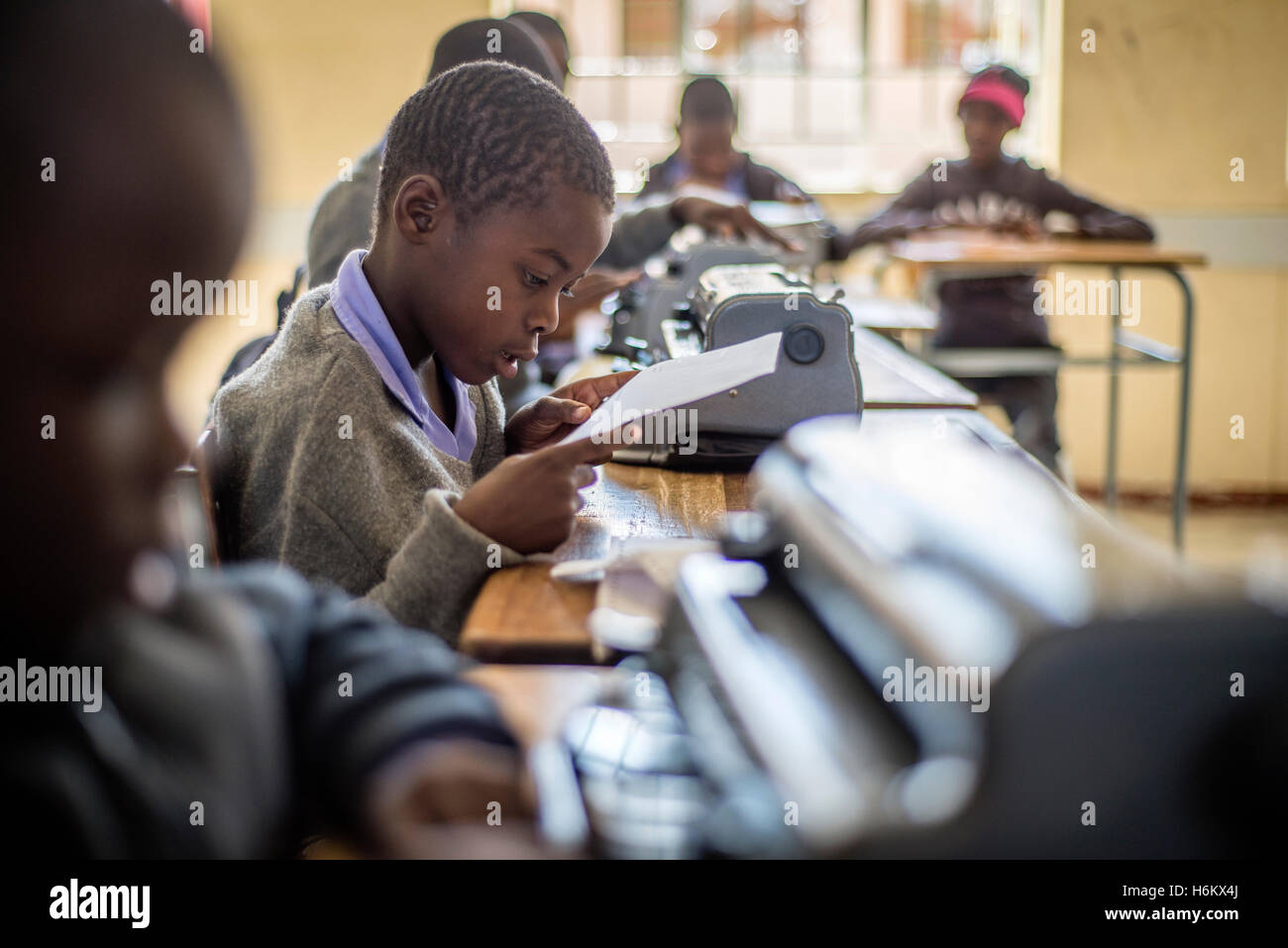Learners of the Eluwa Special School types on a typewriter during ...