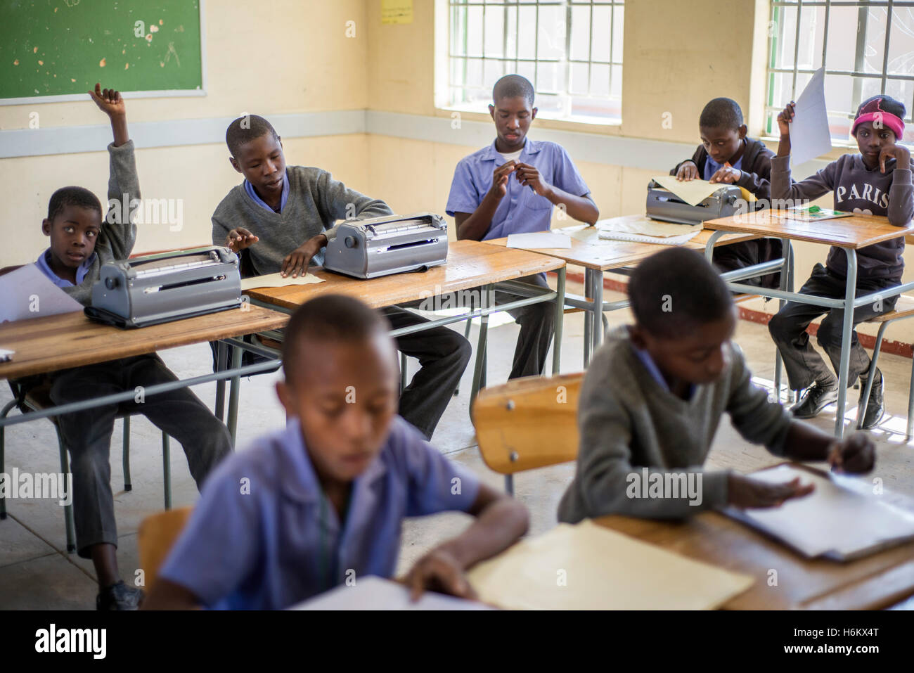 Learners of the Eluwa Special School types on a typewriter during ...