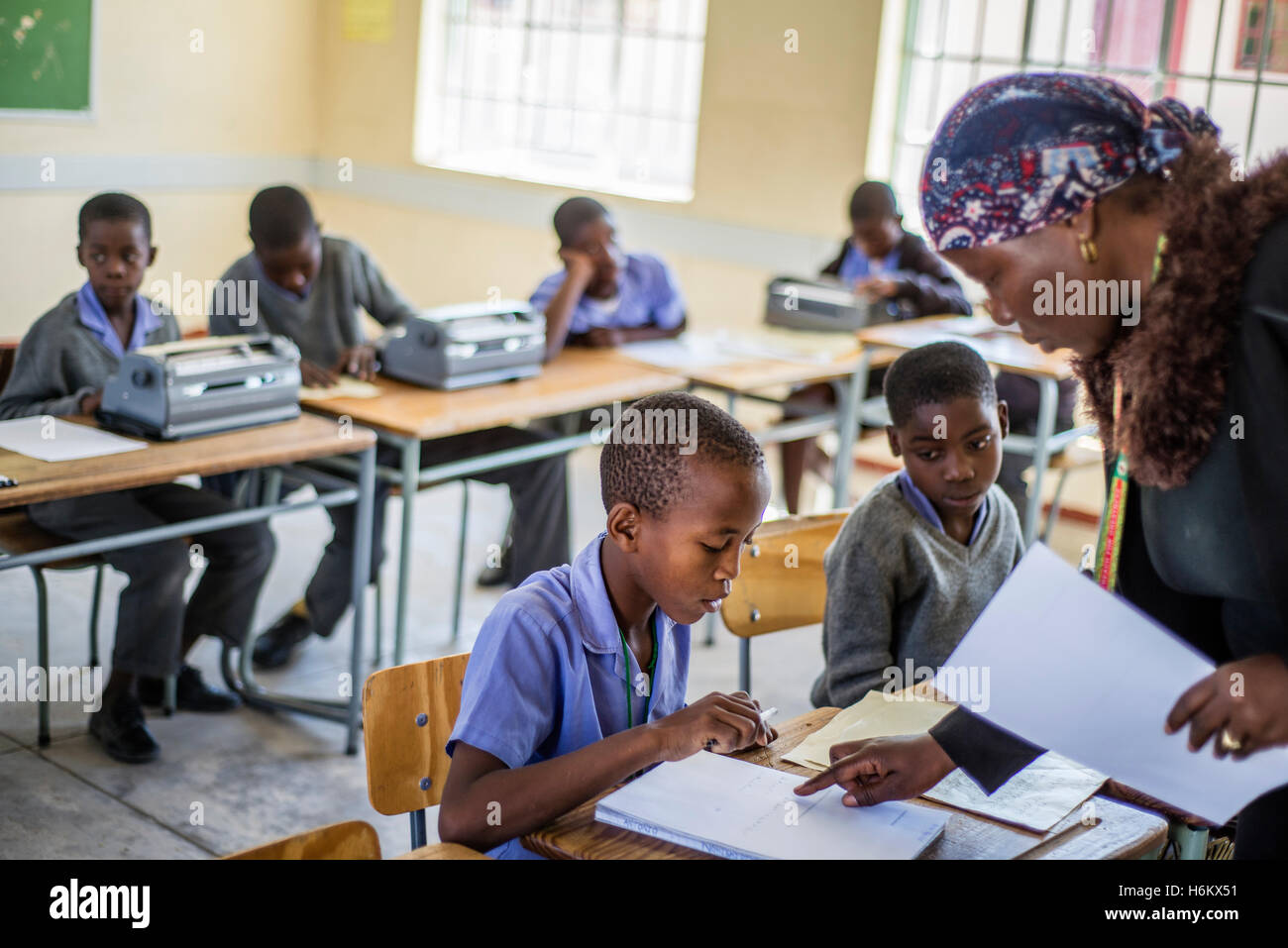 Learners of the Eluwa Special School types on a typewriter during ...