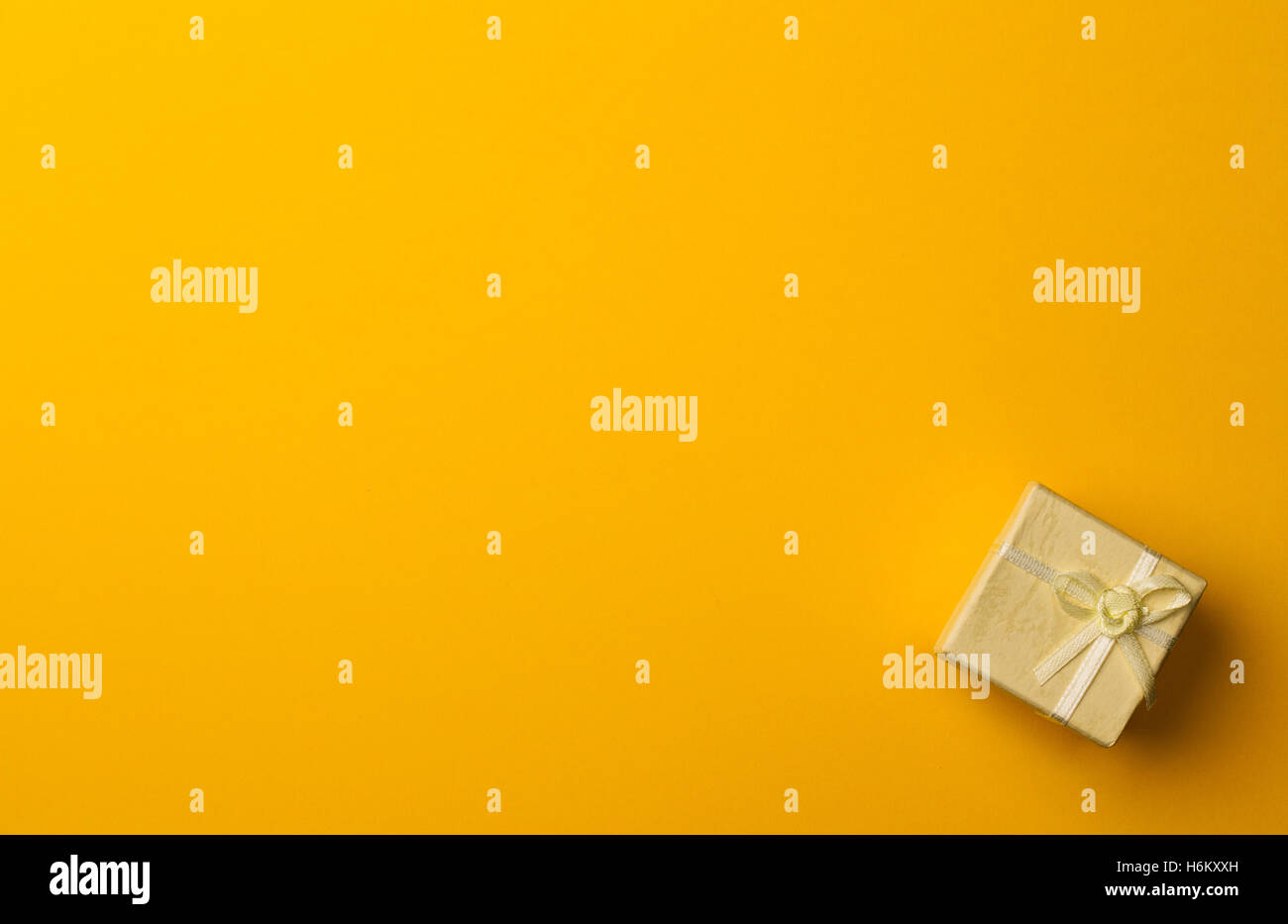 horizontal top view of gift box on minimal yellow background paper ...