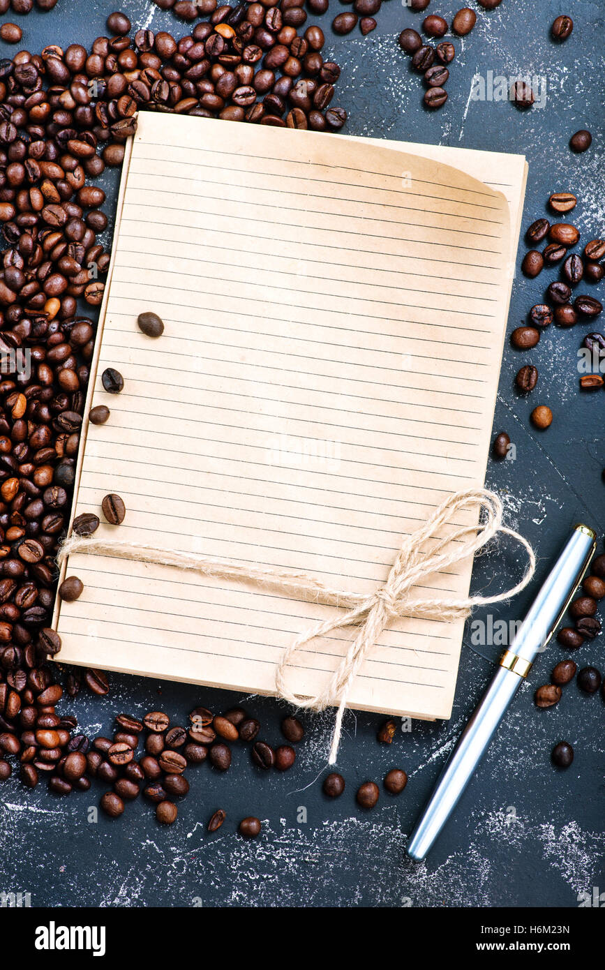 coffee beans and note on a table Stock Photo - Alamy