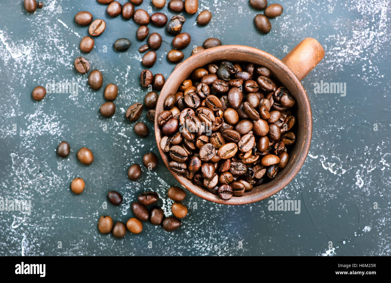 coffee beans in cup and on a table Stock Photo - Alamy