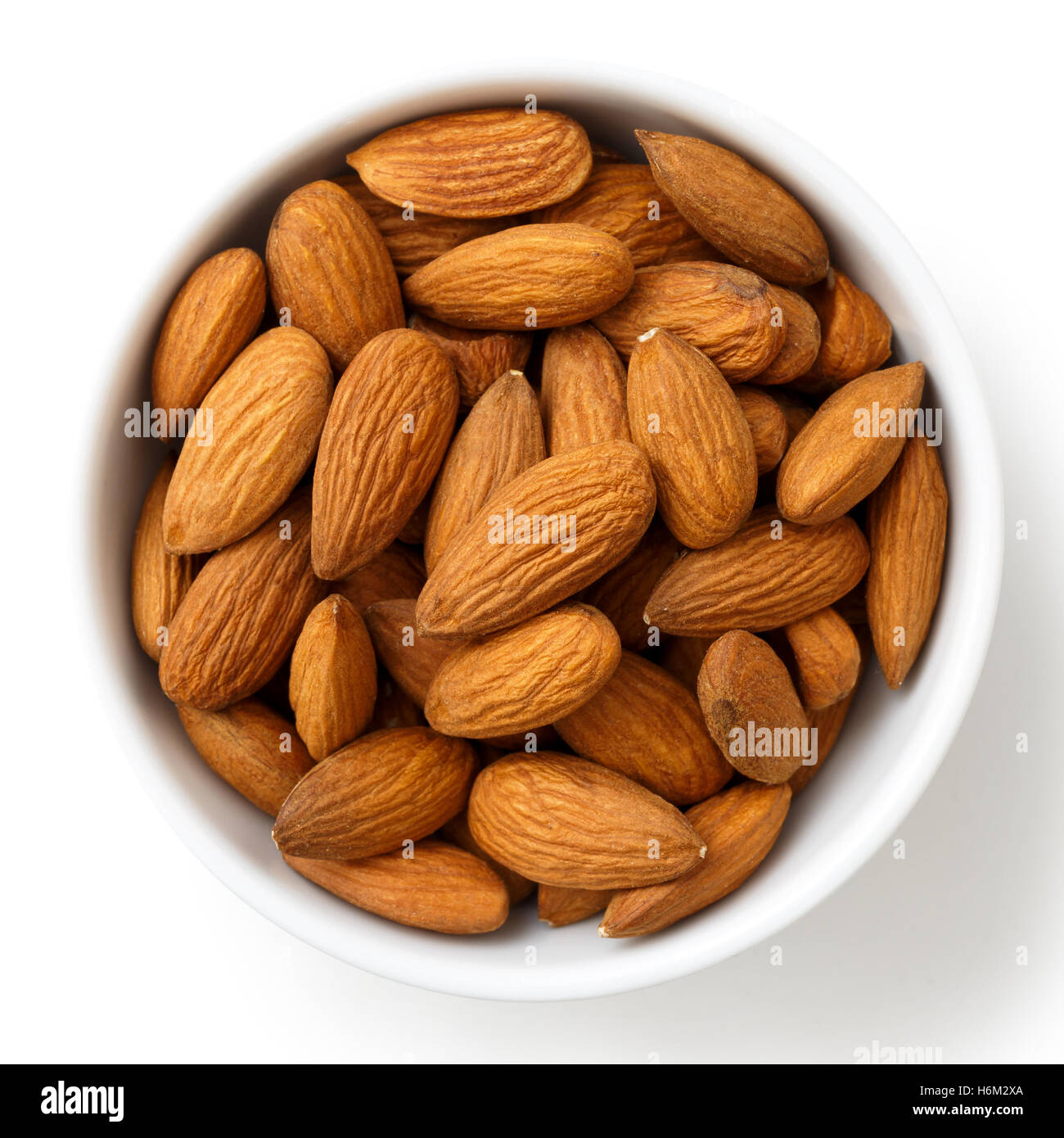 Bowl of whole almonds isolated on white from above Stock Photo - Alamy
