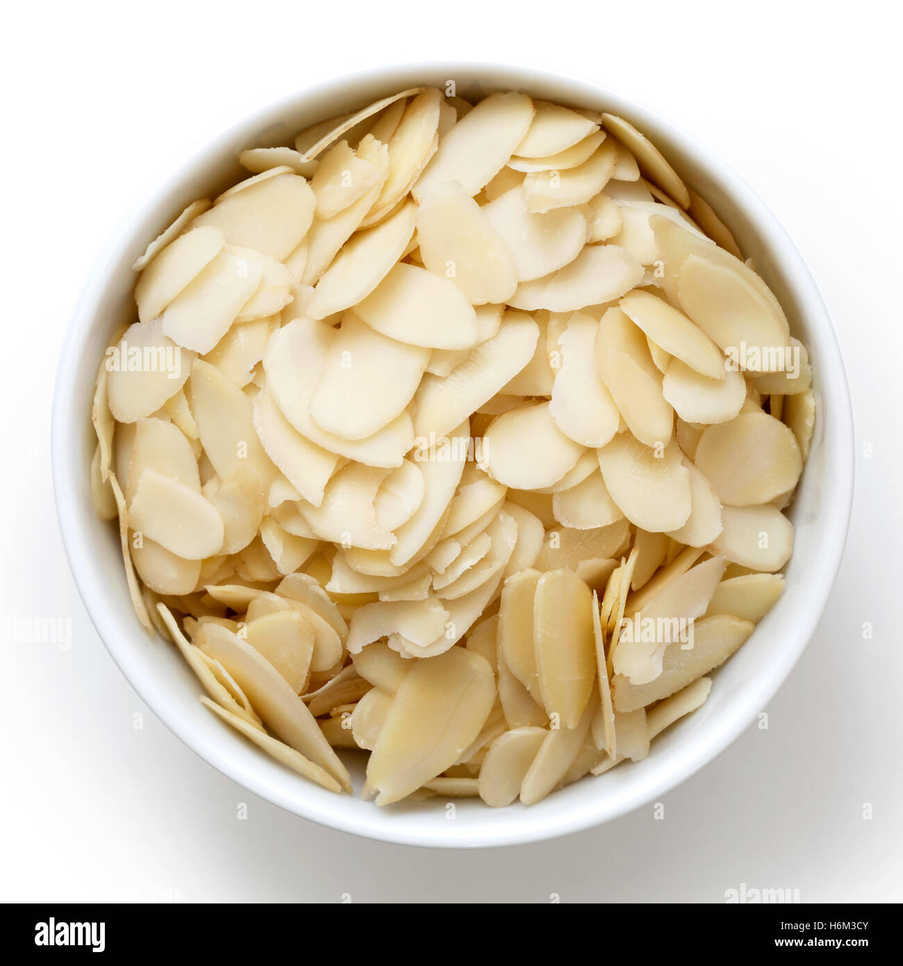 Bowl of peeled flaked almonds isolated on white from above Stock Photo ...
