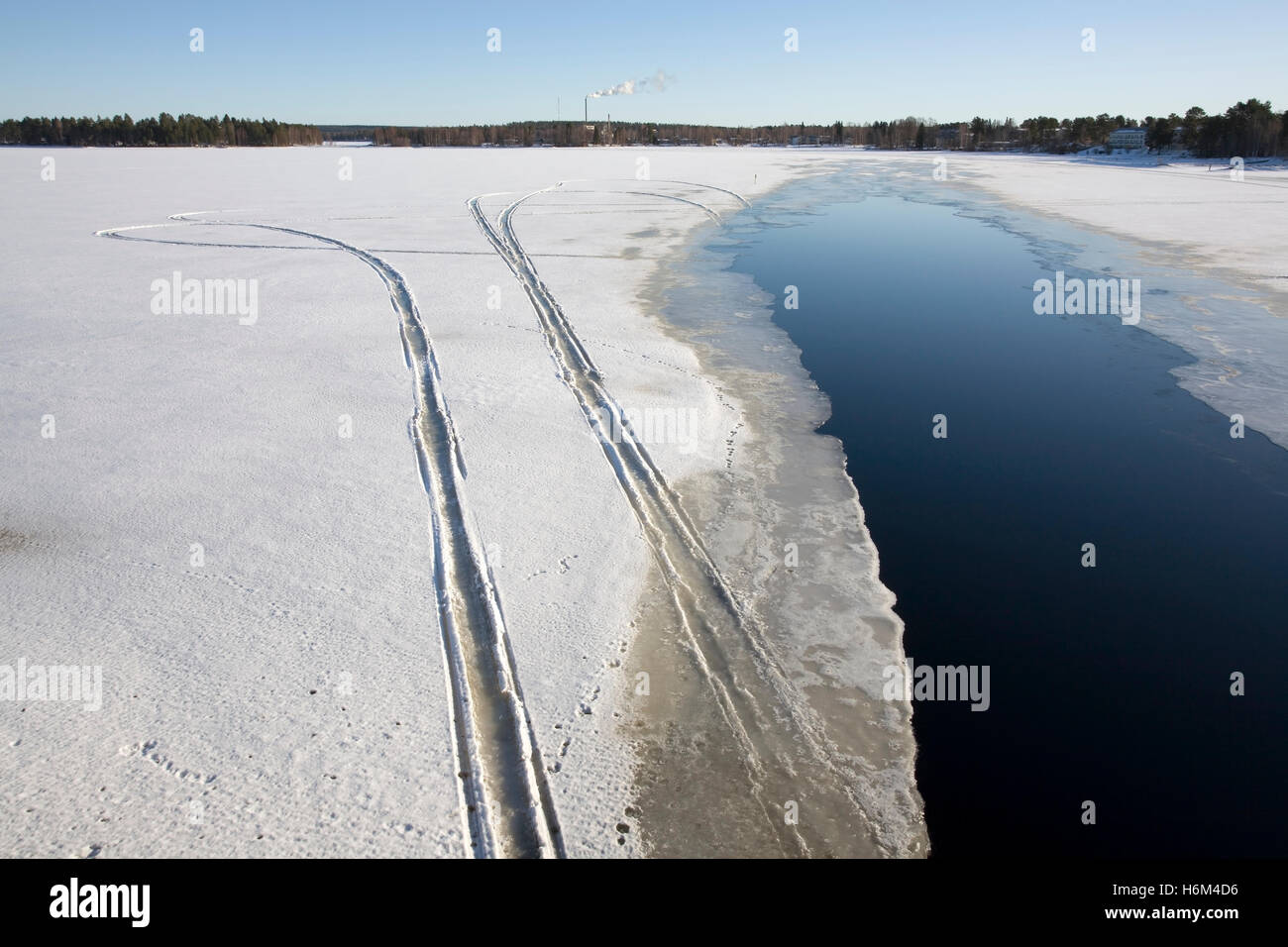 snowmobile trails on melting ice, Finland Stock Photo - Alamy