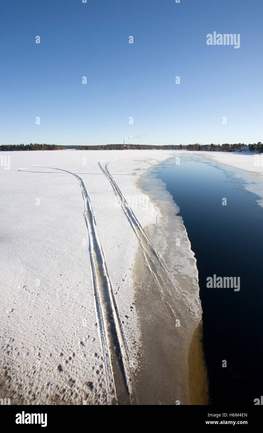 snowmobile trails on melting ice, Finland Stock Photo - Alamy