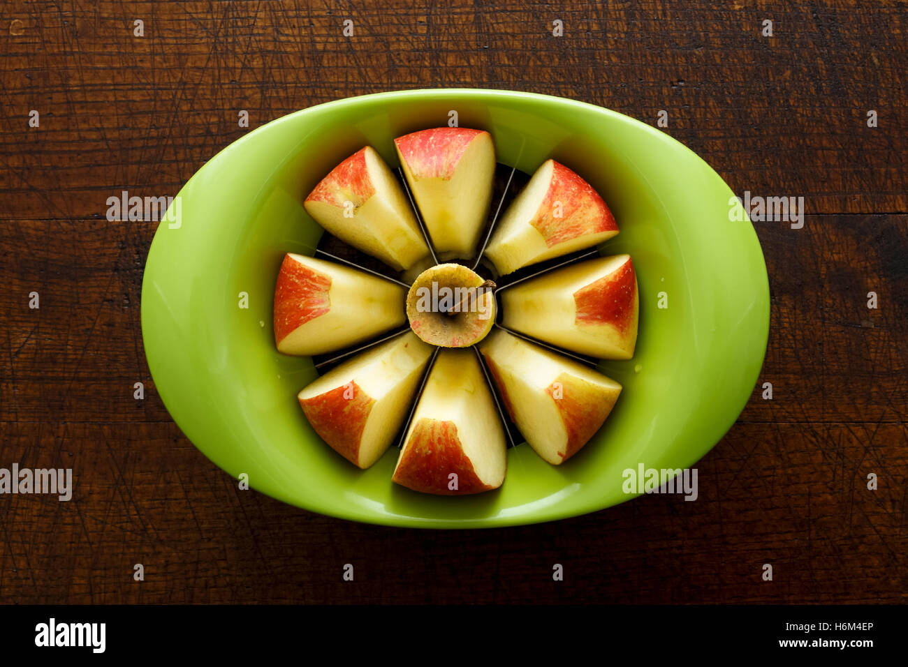 Green apple slicer with sliced apple segments from above, isolated on ...