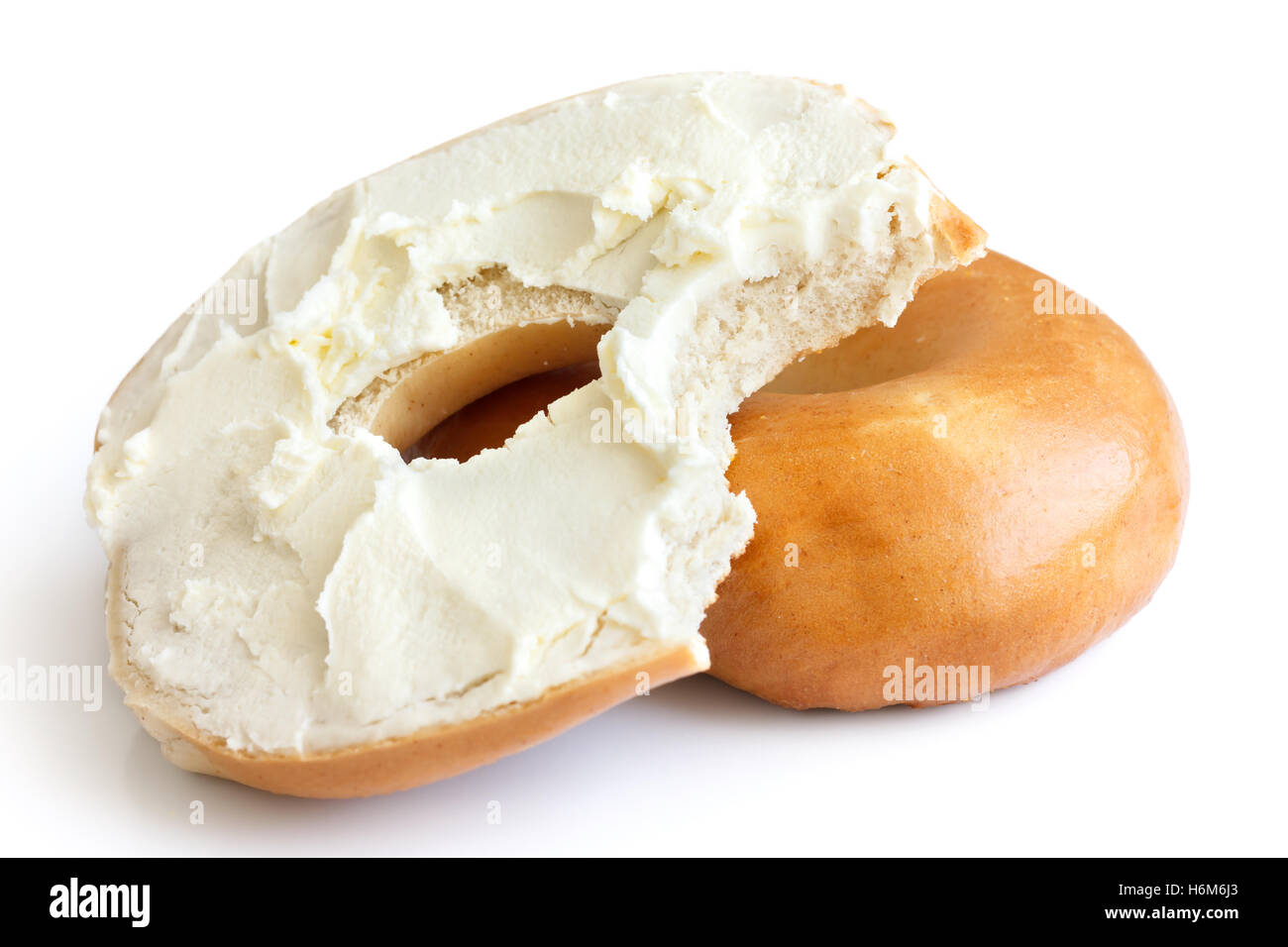 Plain bagel spread with cream cheese and bite missing. Isolated Stock ...