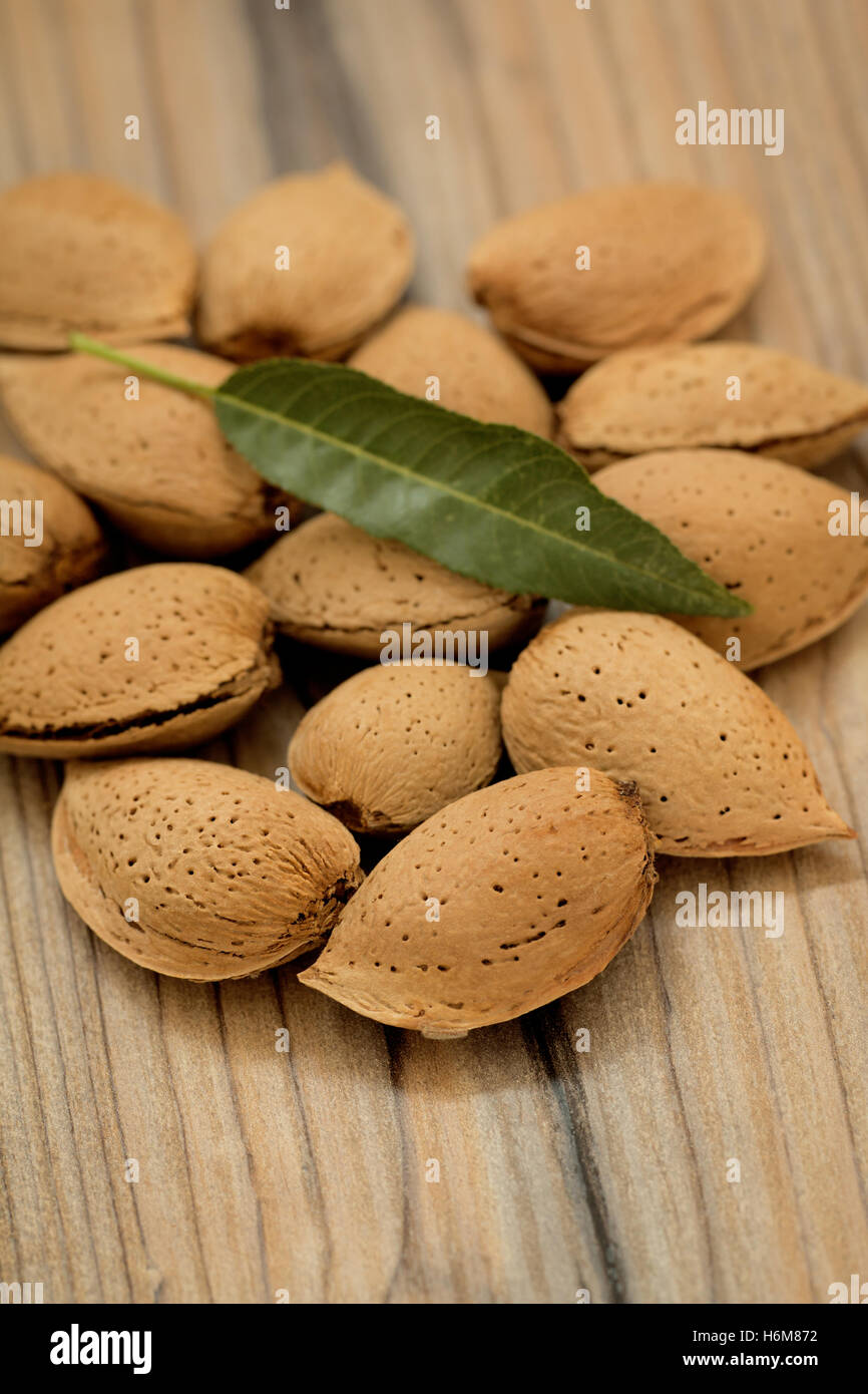 Almonds on brown wooden background. Beneficials for the brain Stock ...