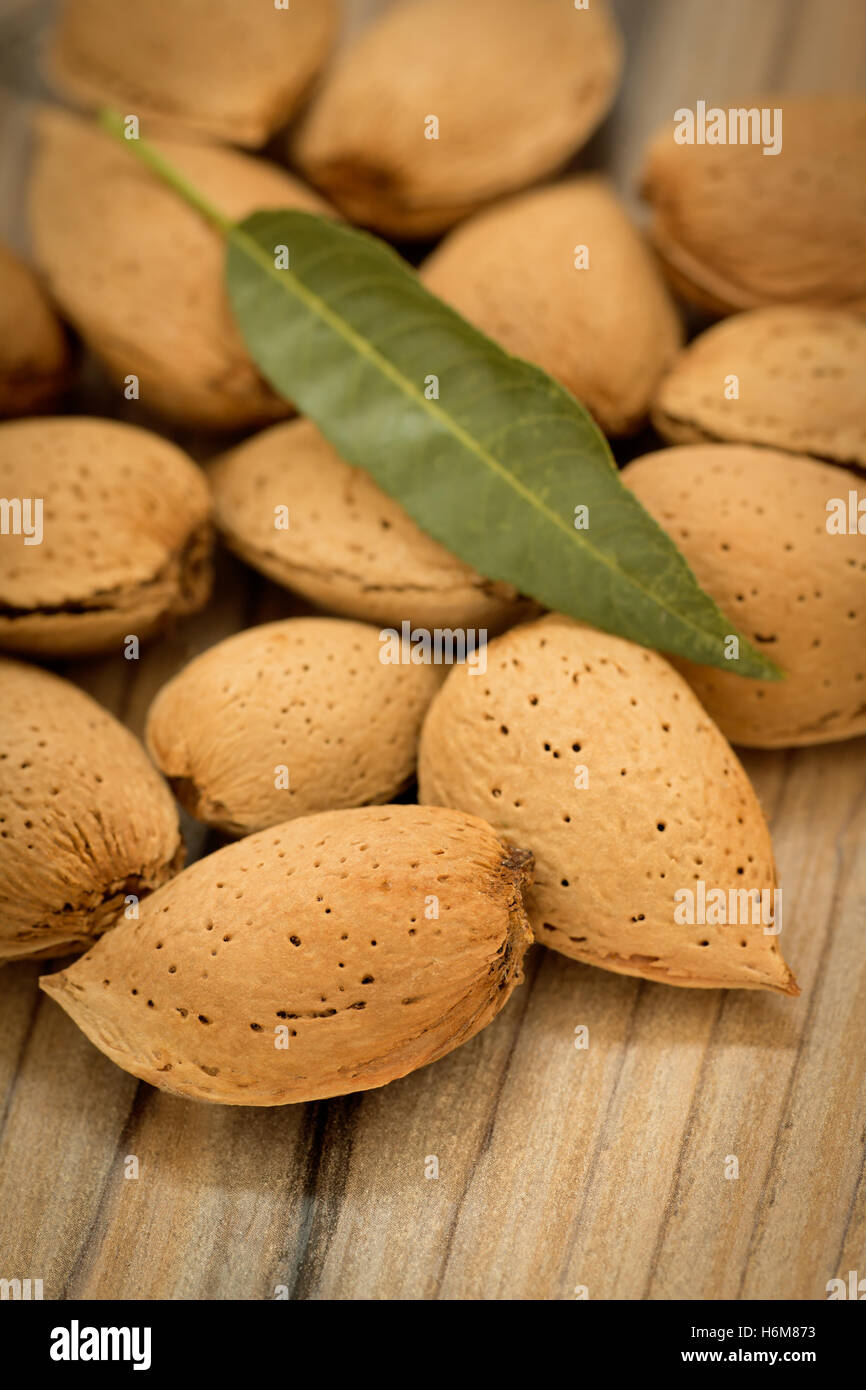Almonds on brown wooden background. Beneficials for the brain Stock ...