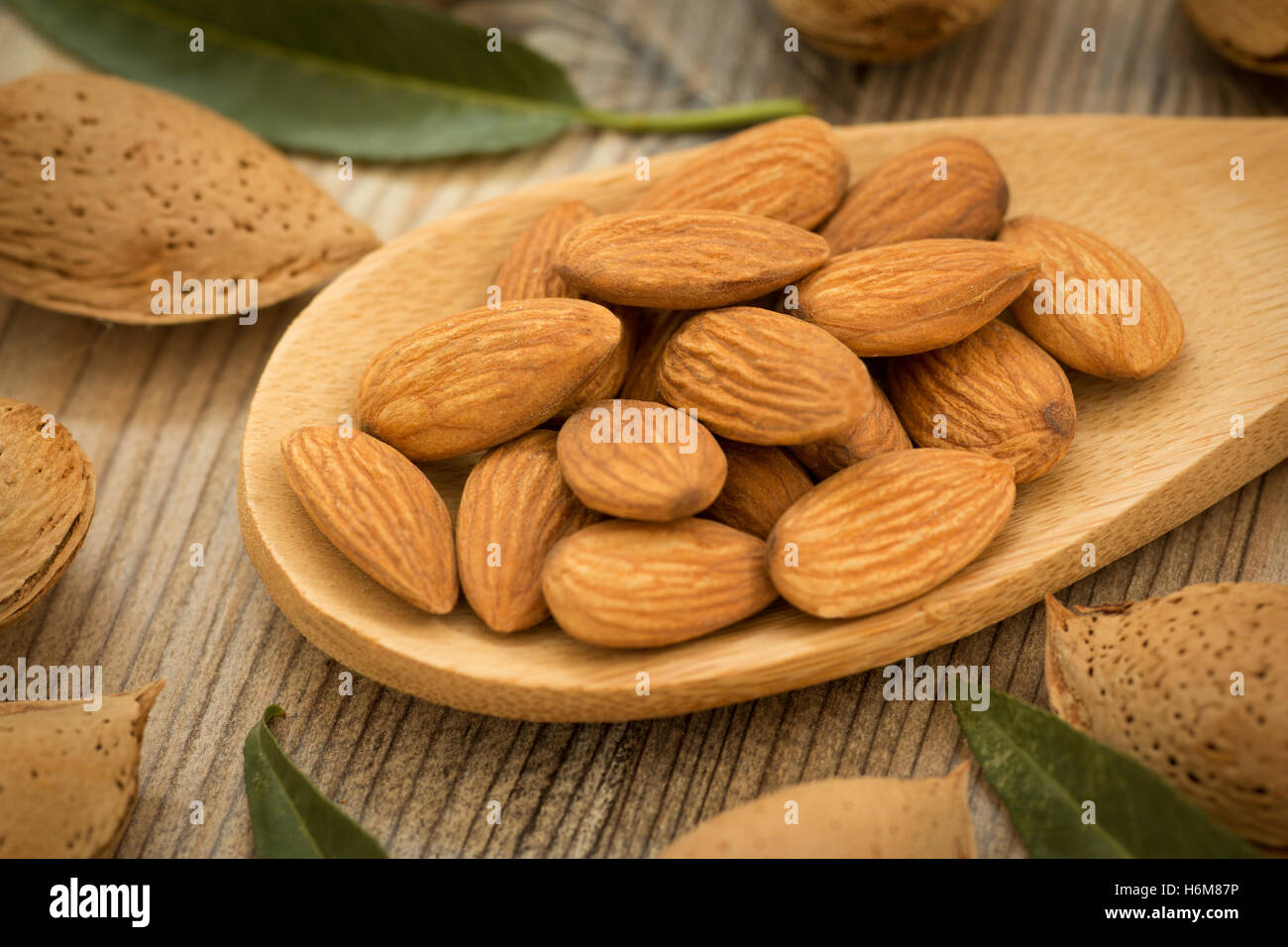 Almonds on brown wooden background. Beneficials for the brain Stock ...