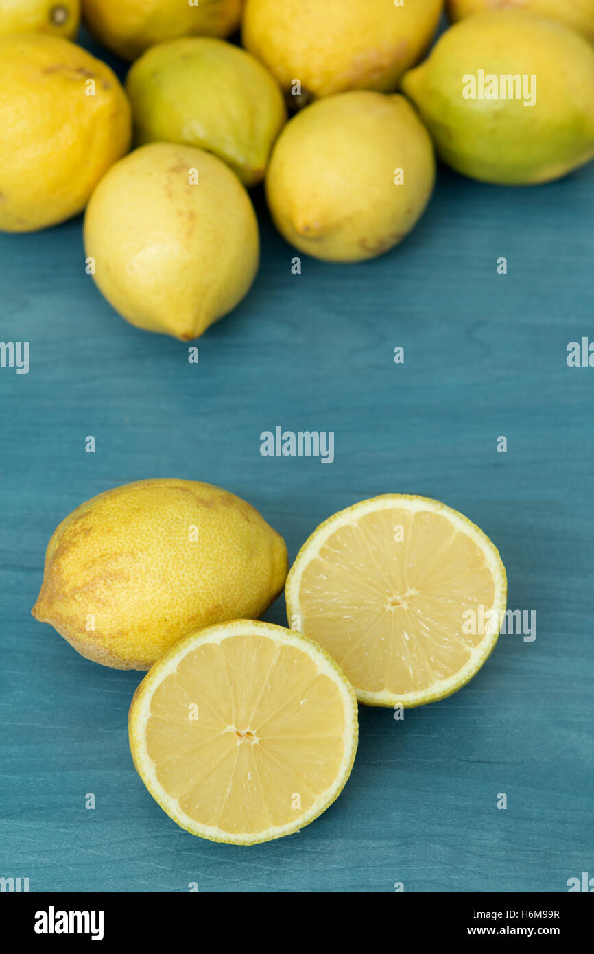 Acid and yellow fruit. Lemons on a blue wood Stock Photo - Alamy