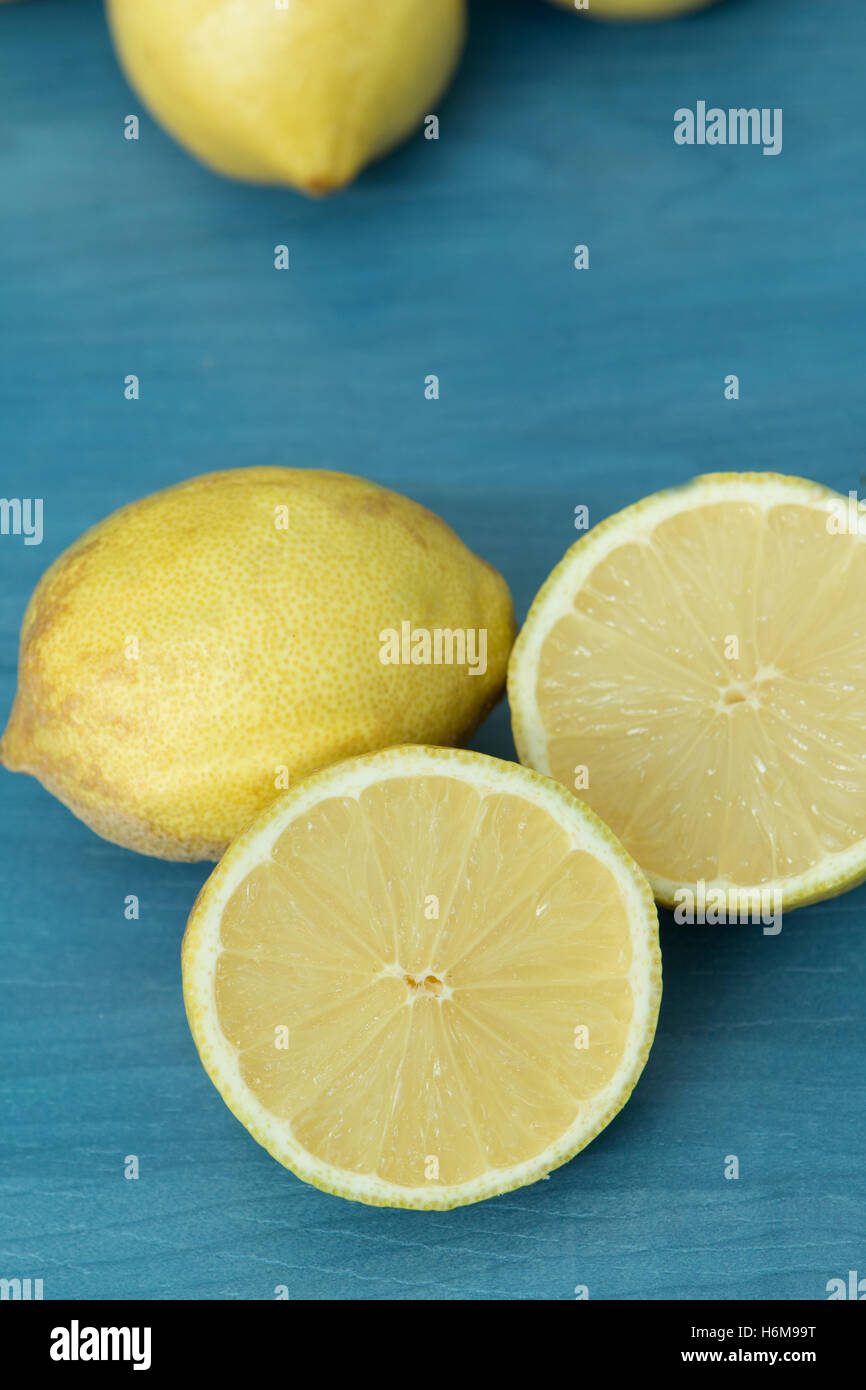 Acid and yellow fruit. Lemons on a blue wood Stock Photo - Alamy