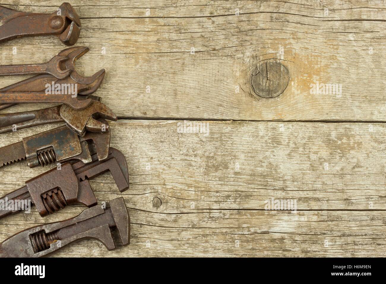 Dirty set of hand tools on a wooden background. Old rusty tools ...