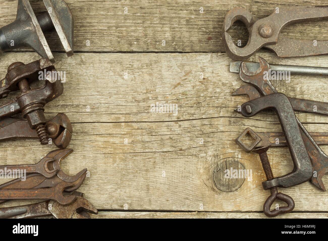 Dirty set of hand tools on a wooden background. Old rusty tools ...