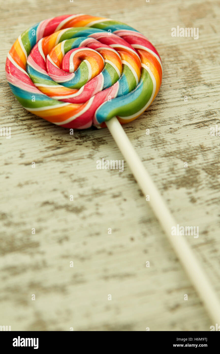 Nice lollipop with many colors in a spiral on a wooden background Stock ...