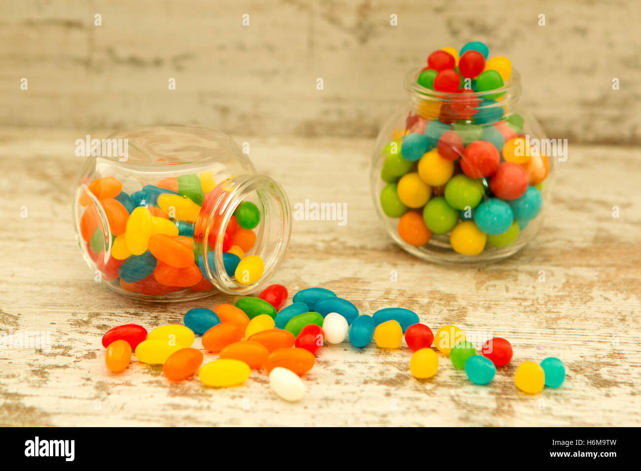 Many candy in glass with differents colors on wooden background Stock ...