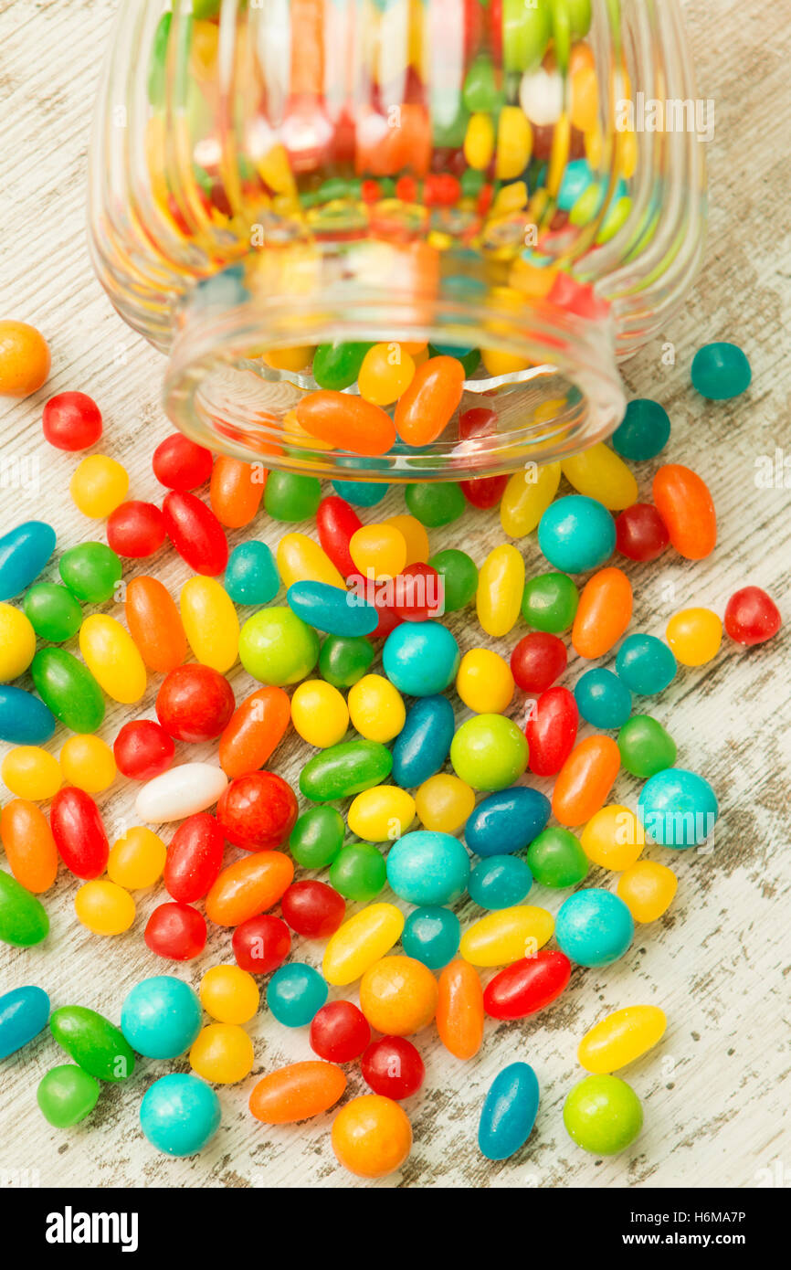 Glass bowl fallen with colorful jelly beans Stock Photo - Alamy
