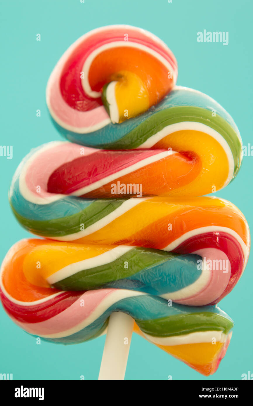 Nice lollipop with many colors in a spiral on a blue background Stock ...