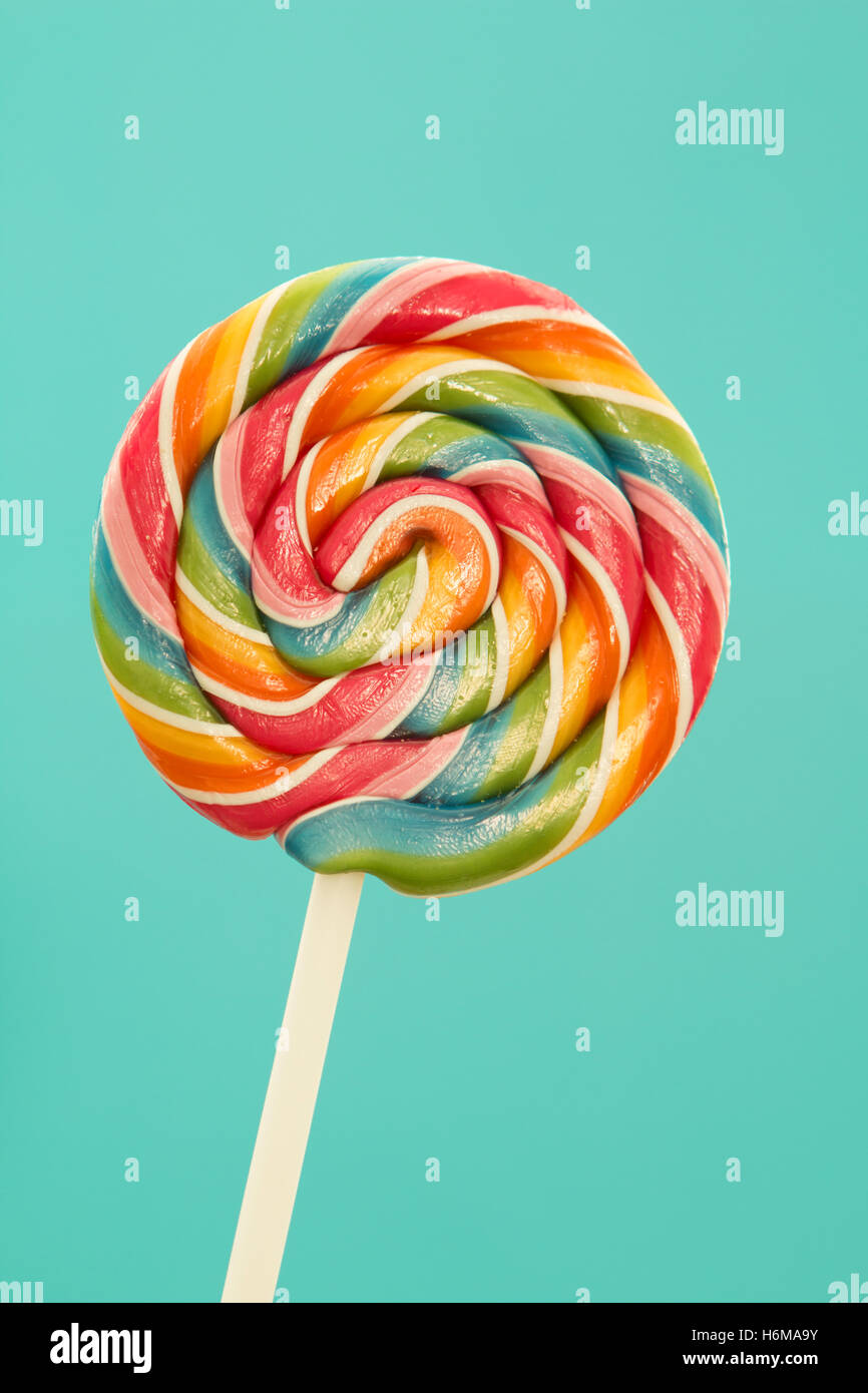 Nice lollipop with many colors in a spiral on a blue background Stock ...